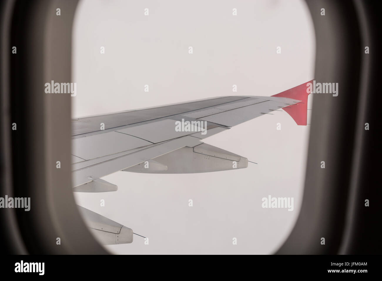 Aircraft windows overlooking the wing of the aircraft Stock Photo - Alamy