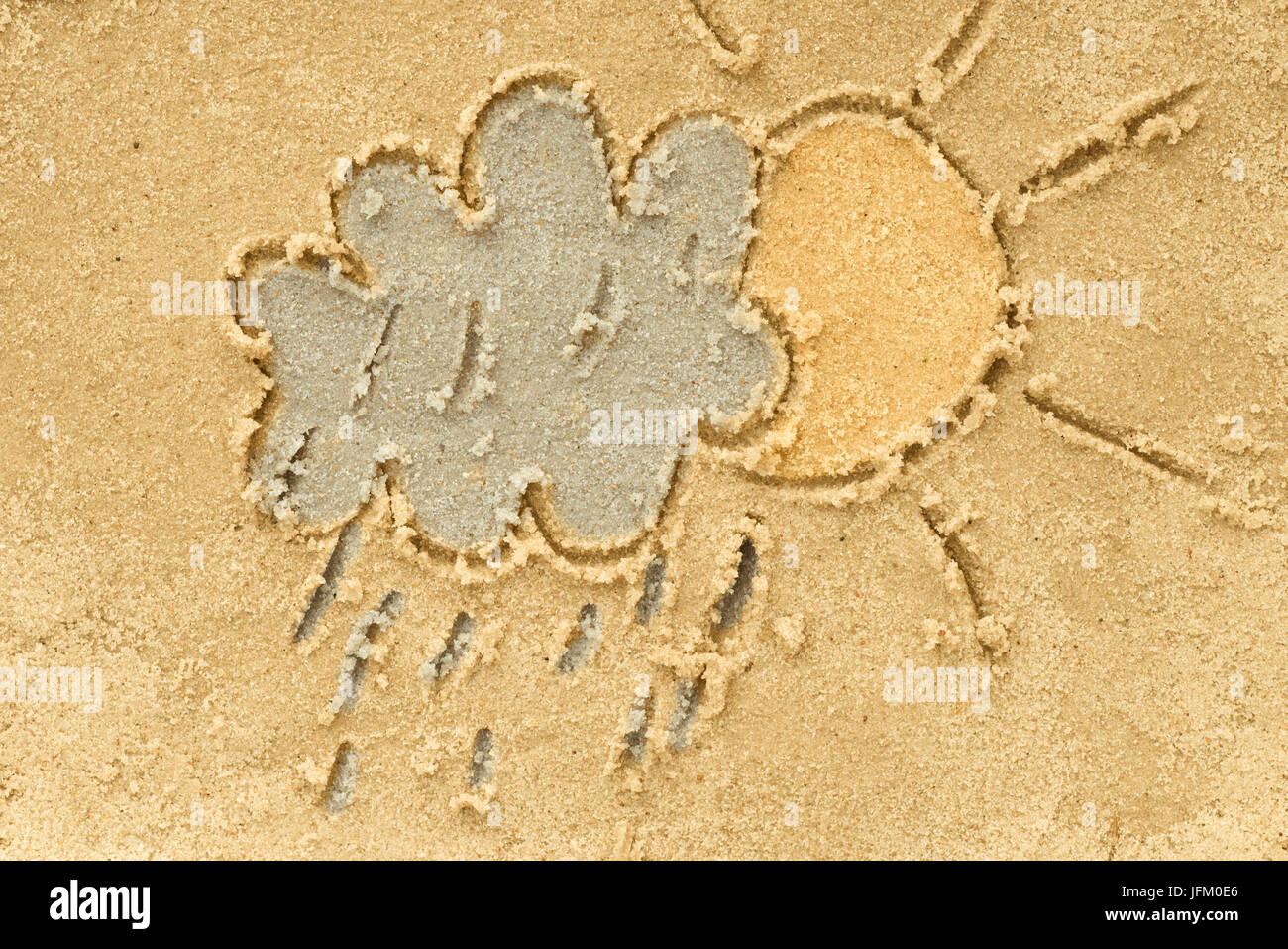 cloud and sun drawing in sand background Stock Photo - Alamy