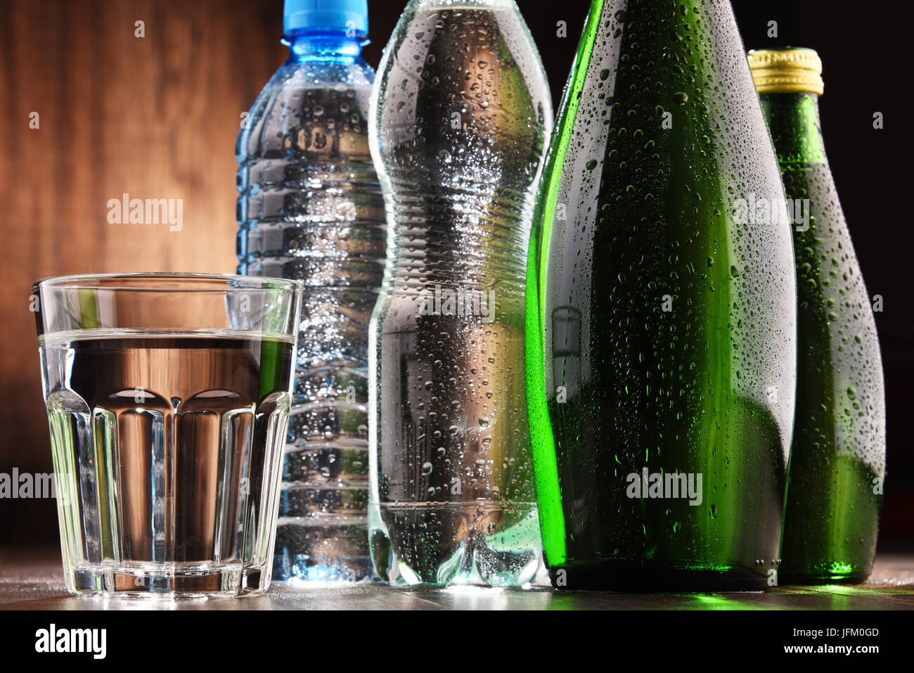 Composition with glass and bottles of mineral water Stock Photo - Alamy