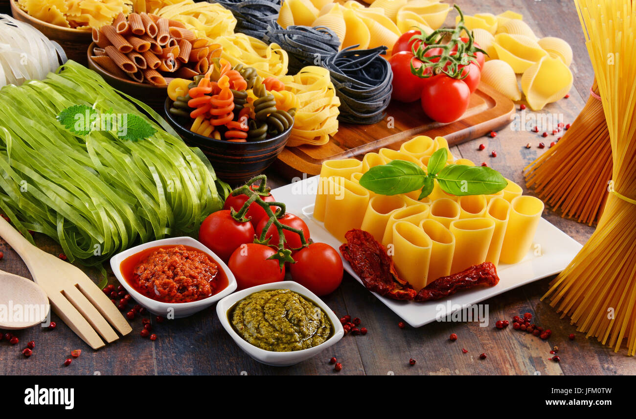 Composition with different sorts of pasta on kitchen table Stock Photo ...
