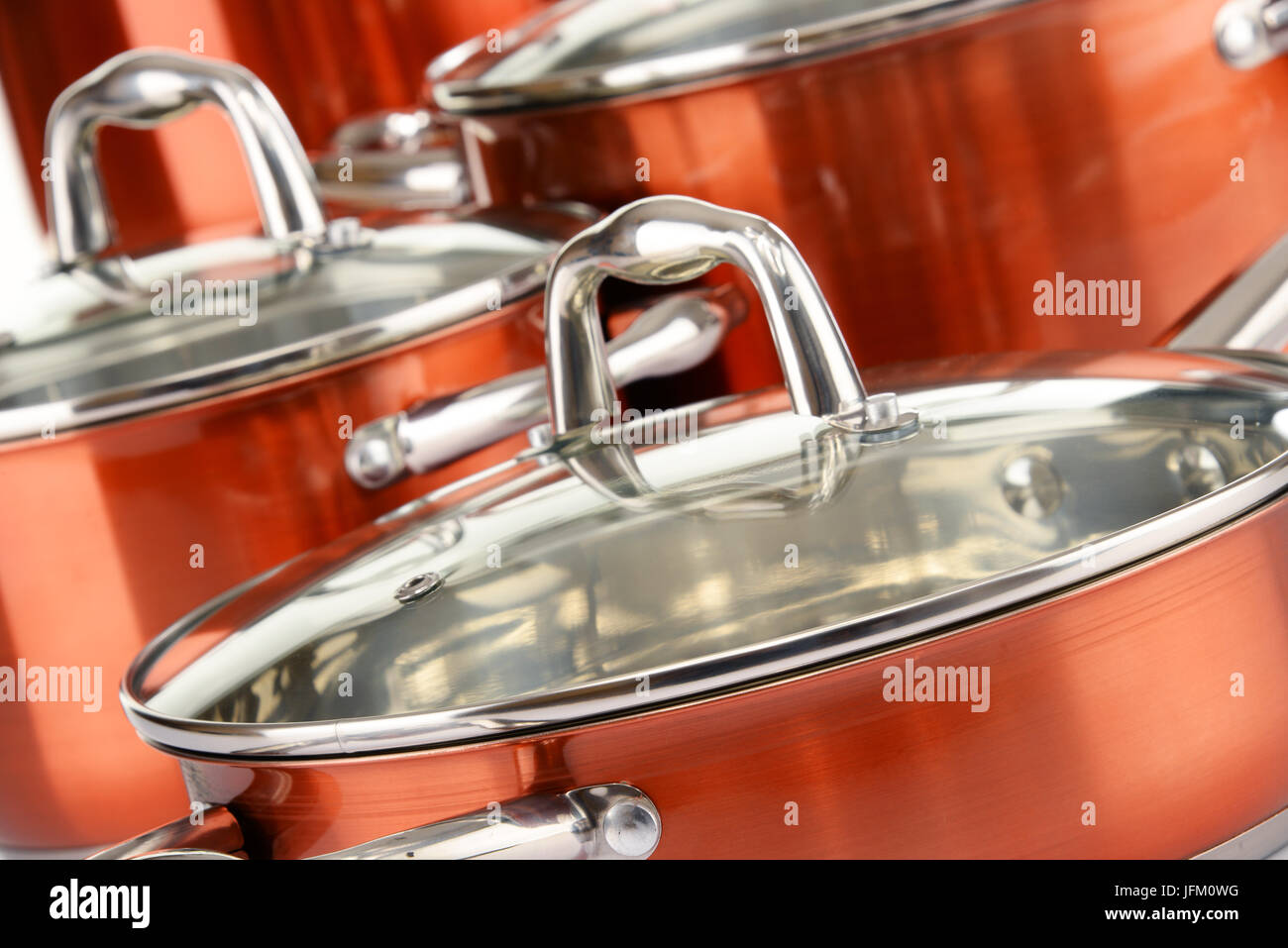 Composition with four steel pots Stock Photo - Alamy