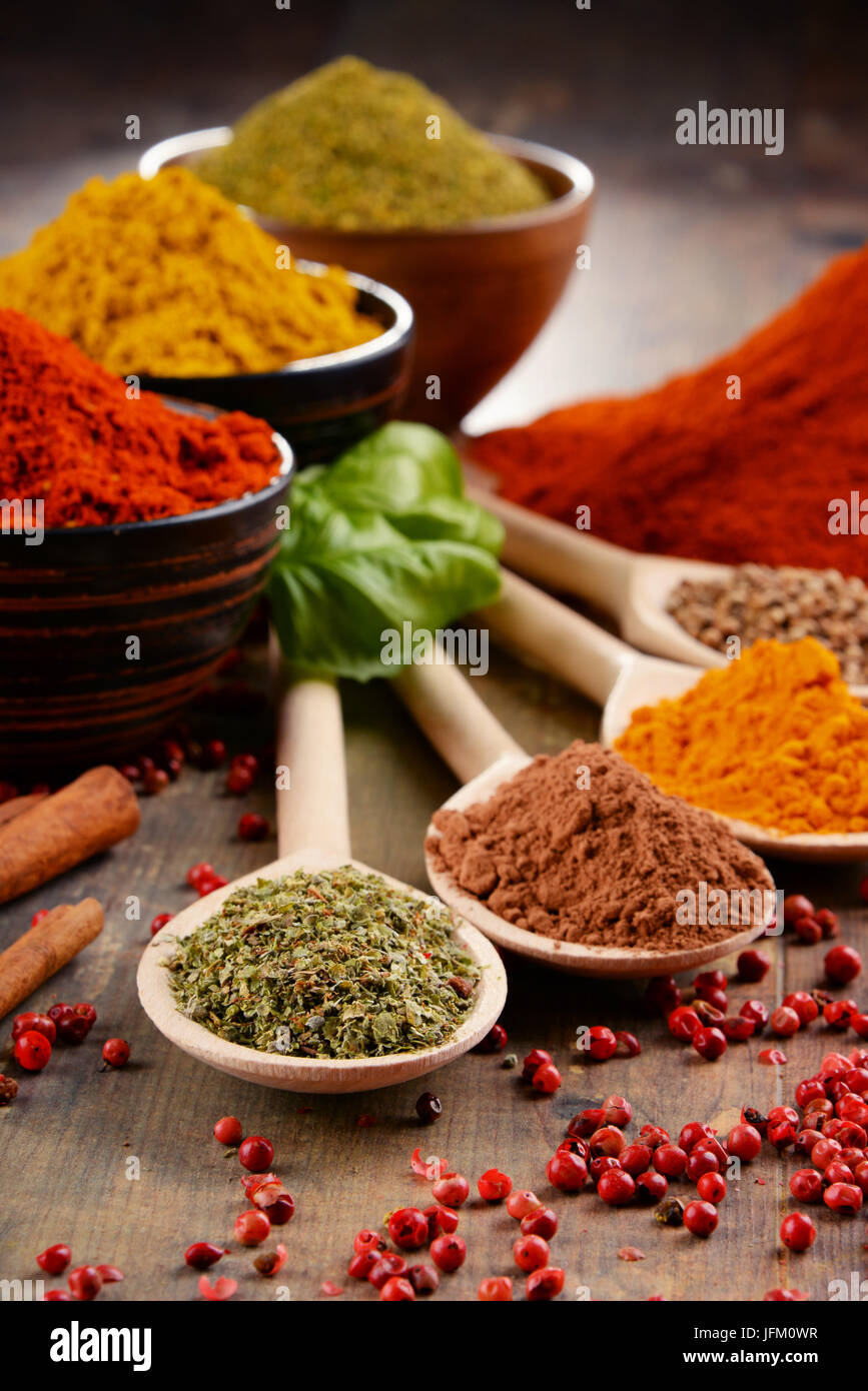 Variety of spices on kitchen table Stock Photo - Alamy