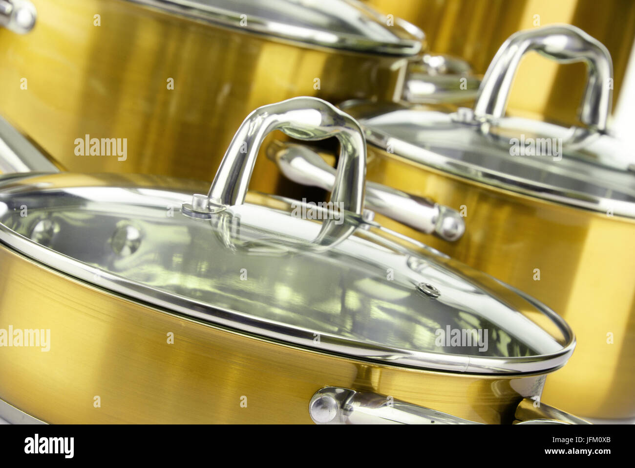 Composition with four steel pots Stock Photo - Alamy