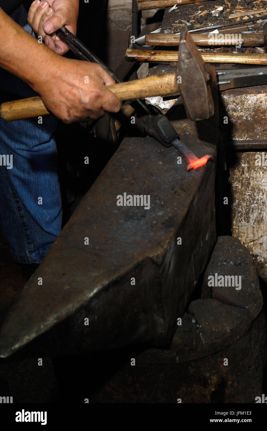 Blacksmith forges iron in the forge Stock Photo - Alamy