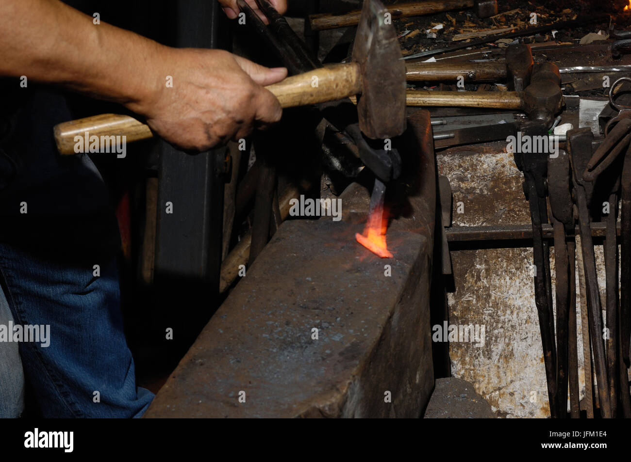 Blacksmith forges iron in the forge Stock Photo - Alamy