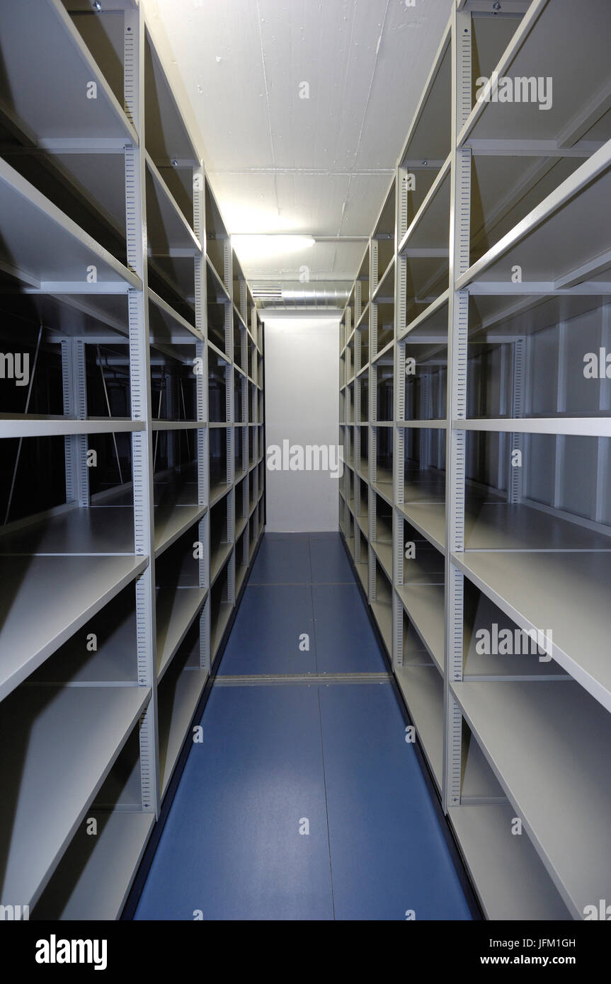 An empty storage unit with shelving on both walls Stock Photo - Alamy