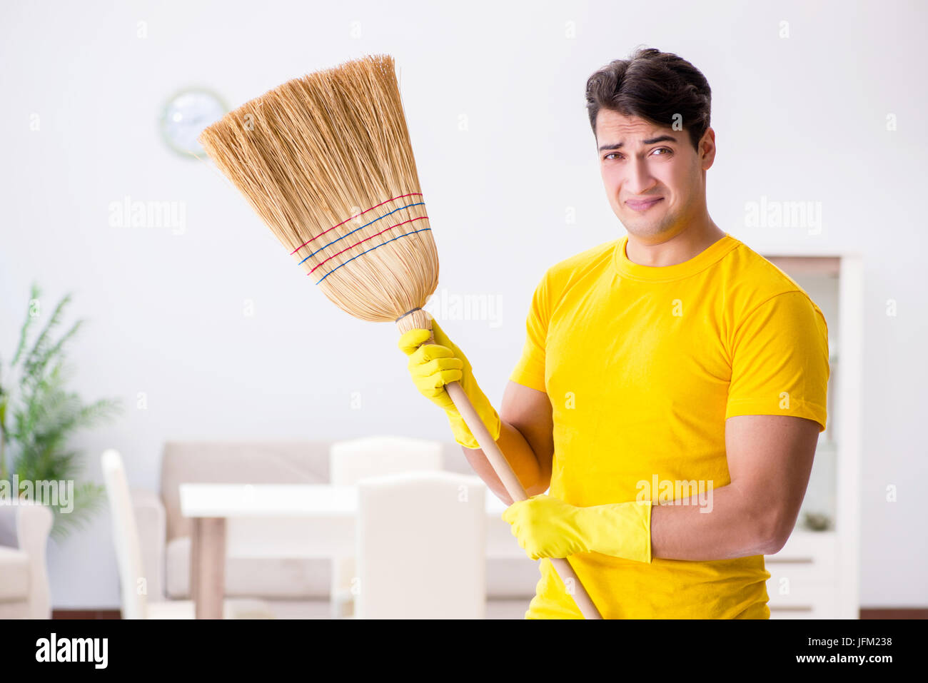 Man husband cleaning the house helping his wife Stock Photo - Alamy