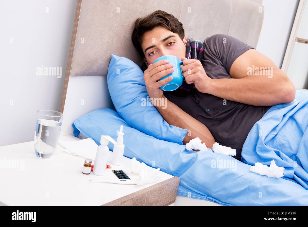 Sick ill man in the bed taking medicines and drugs Stock Photo - Alamy