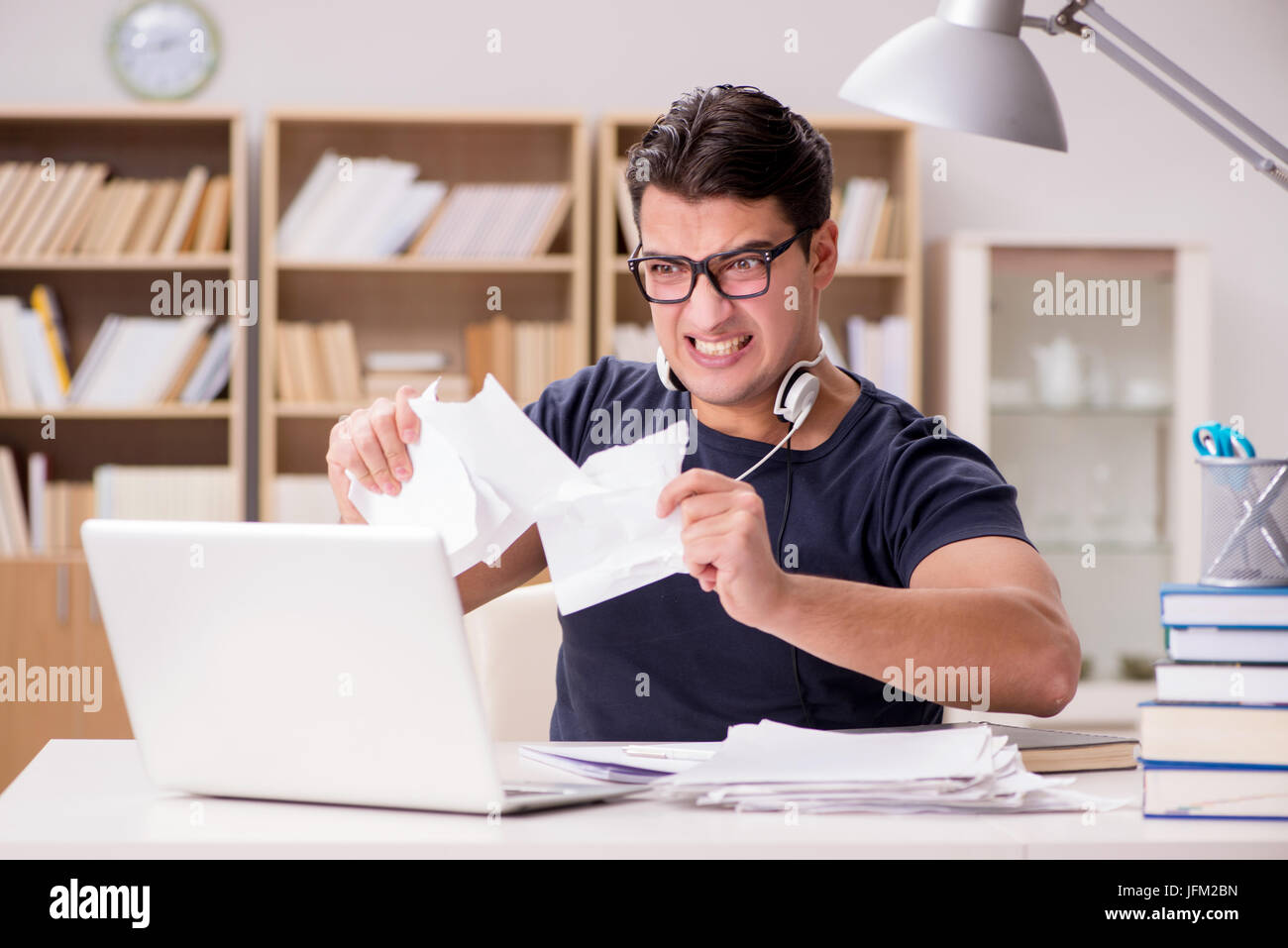 Angry man tearing apart his paperwork due to stress Stock Photo - Alamy