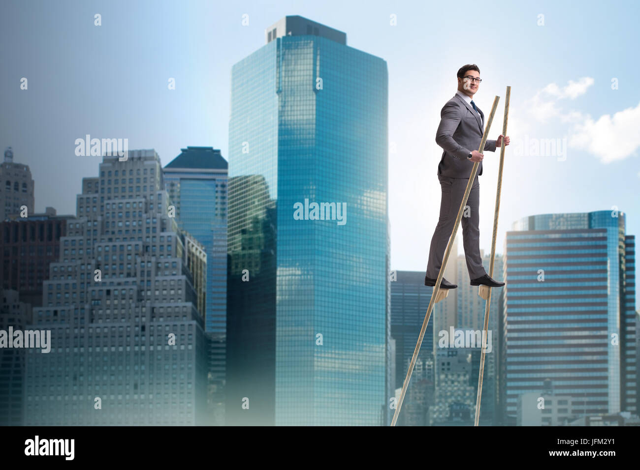 Businessman walking on stilts - standing out from the crowd Stock Photo ...