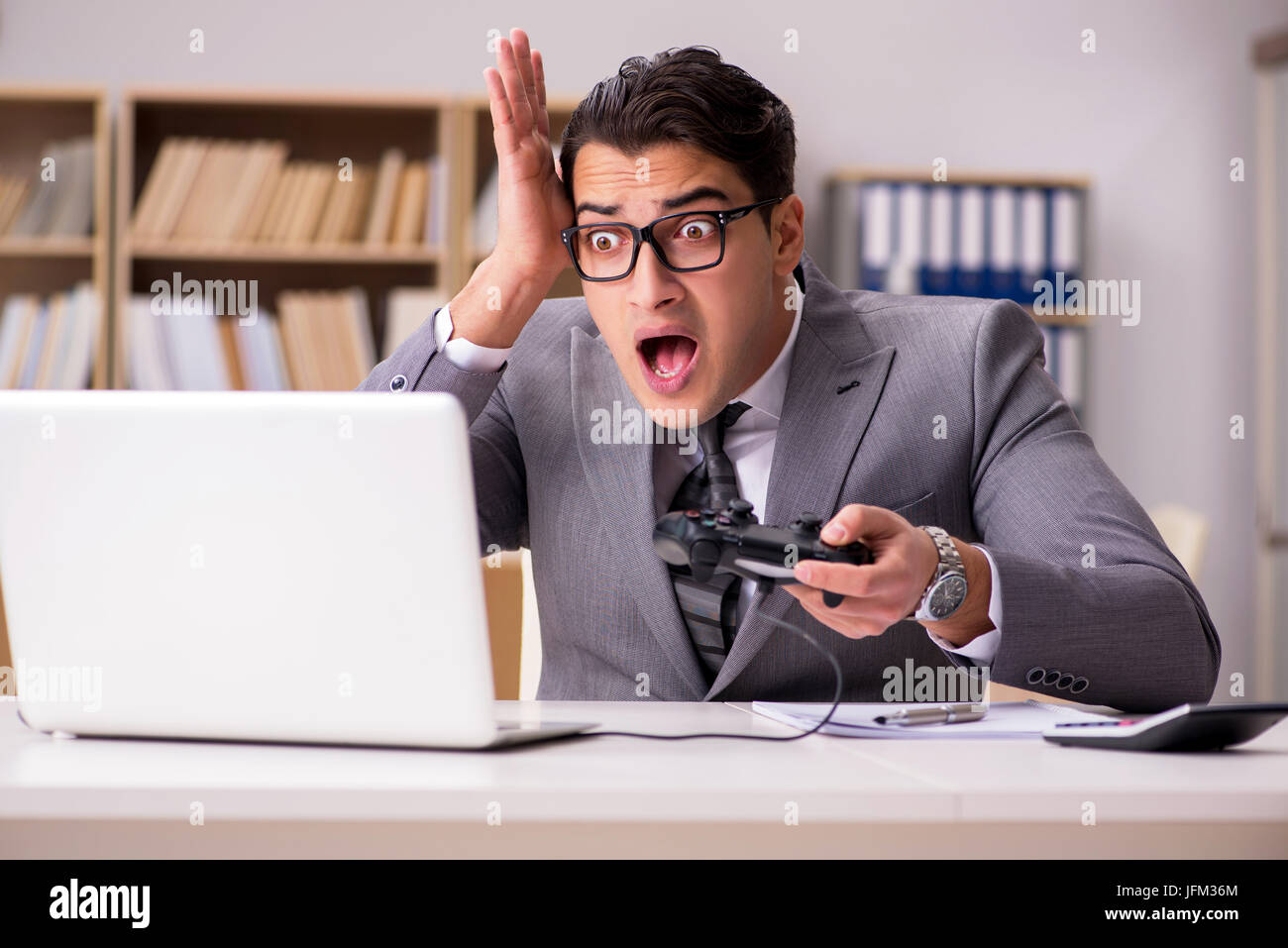 Businessman playing computer games at work office Stock Photo - Alamy