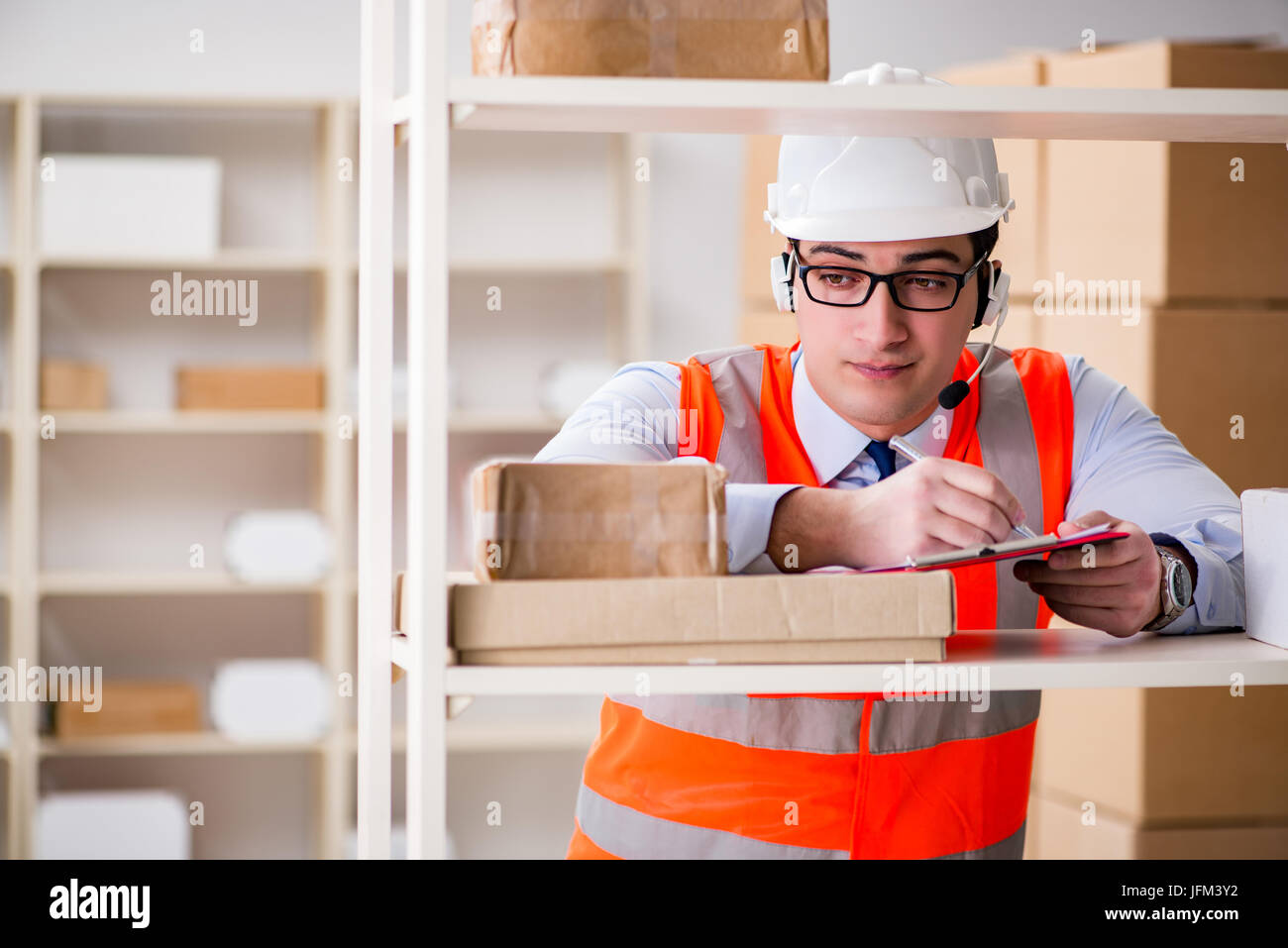 Man working in postal parcel delivery service office Stock Photo - Alamy