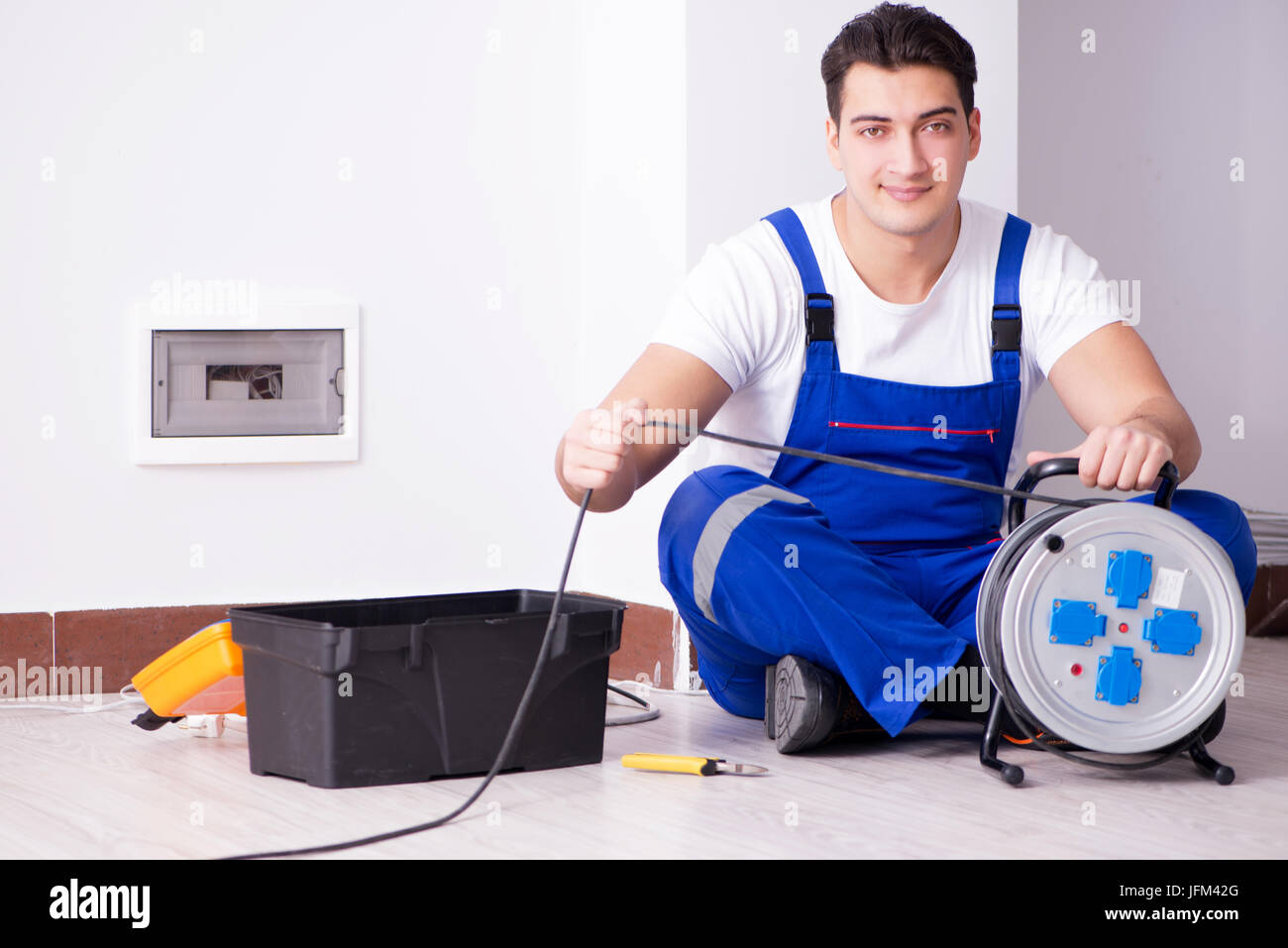 Young electrician installing socket hi-res stock photography and images ...