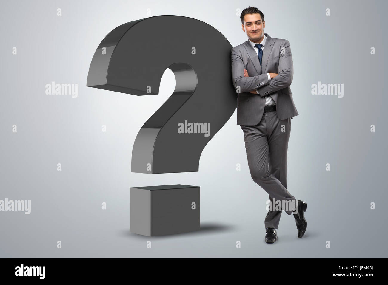 Businessman next to the giant question mark Stock Photo - Alamy