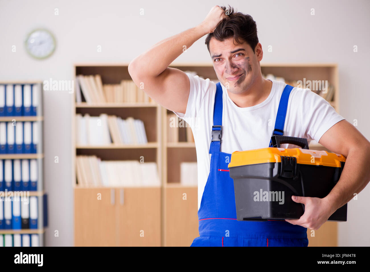 Funny worker with dirty face and toolkit Stock Photo - Alamy