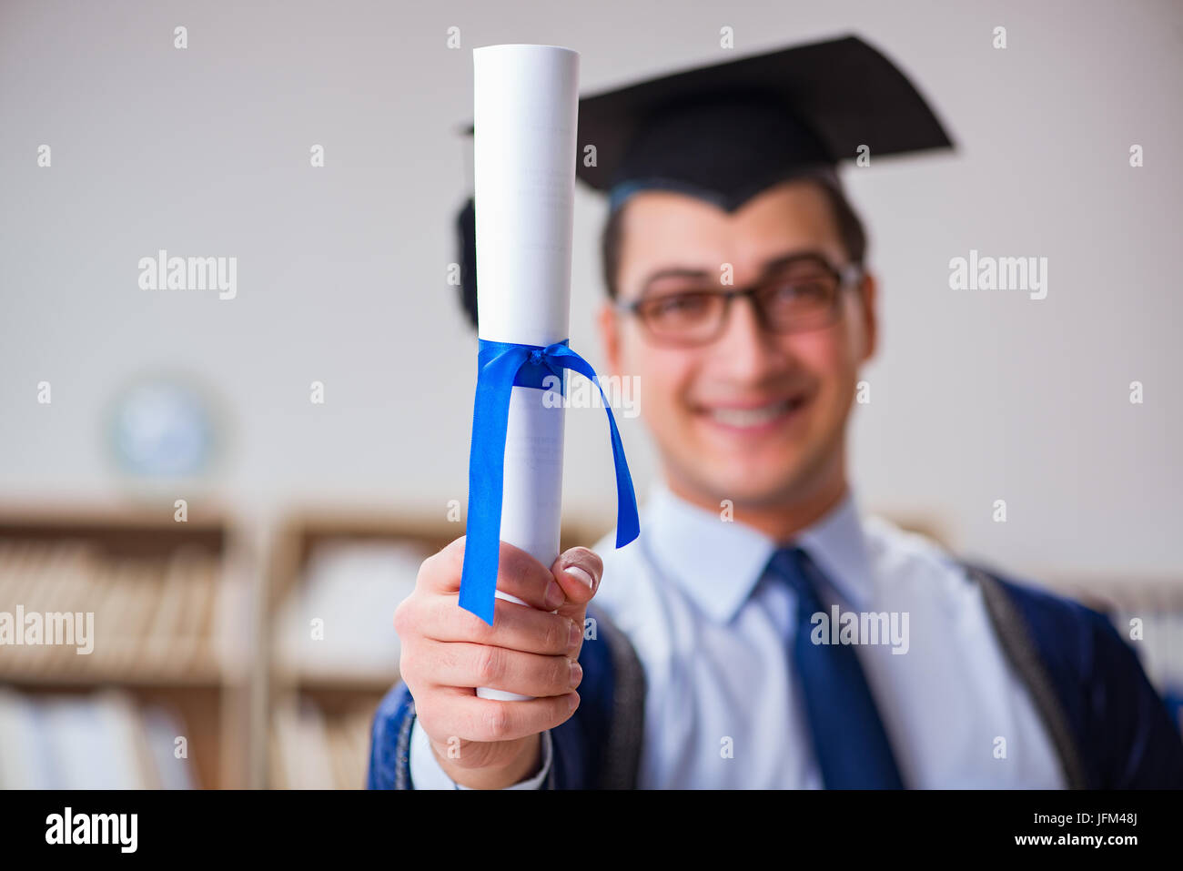 Young man graduating from university Stock Photo - Alamy