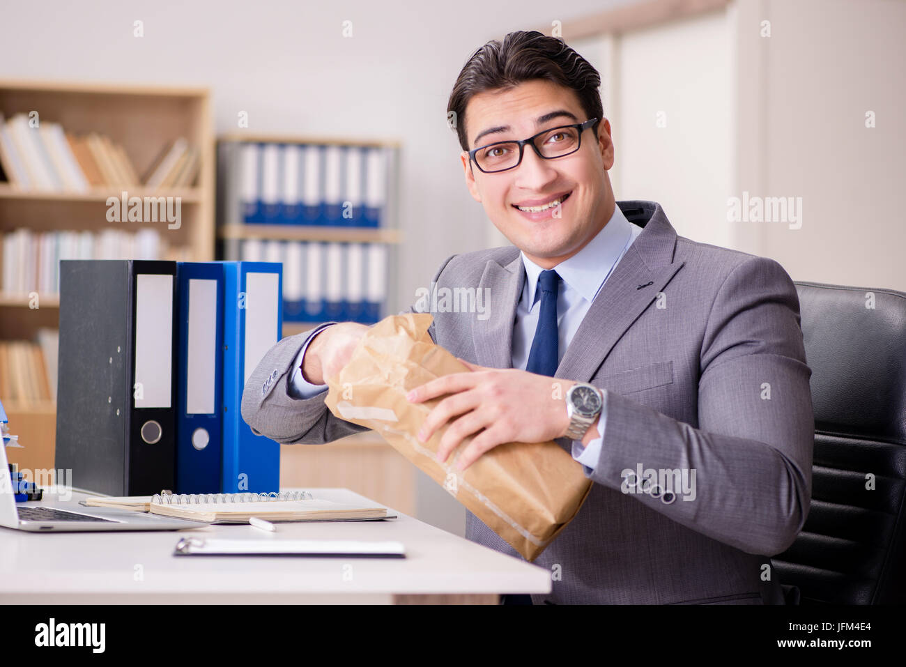 Businessman receiving parcel in the office Stock Photo - Alamy
