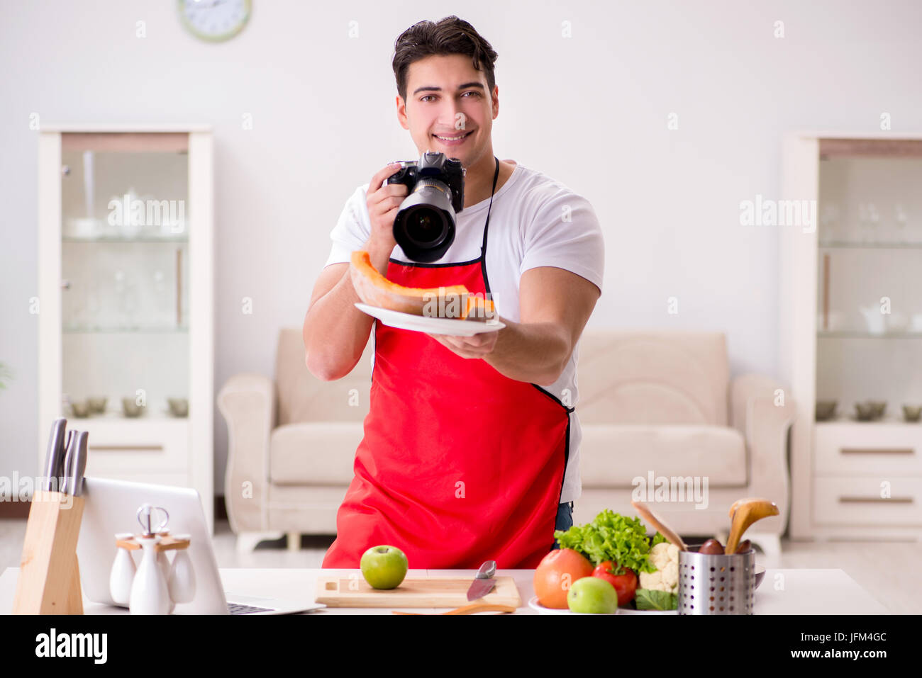 Food photographer taking photos in kitchen Stock Photo - Alamy