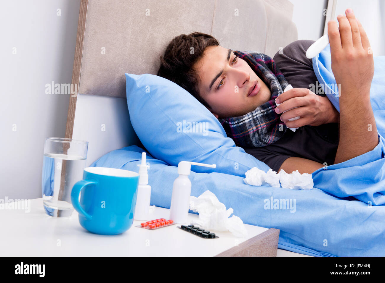 Sick ill man in the bed taking medicines and drugs Stock Photo - Alamy