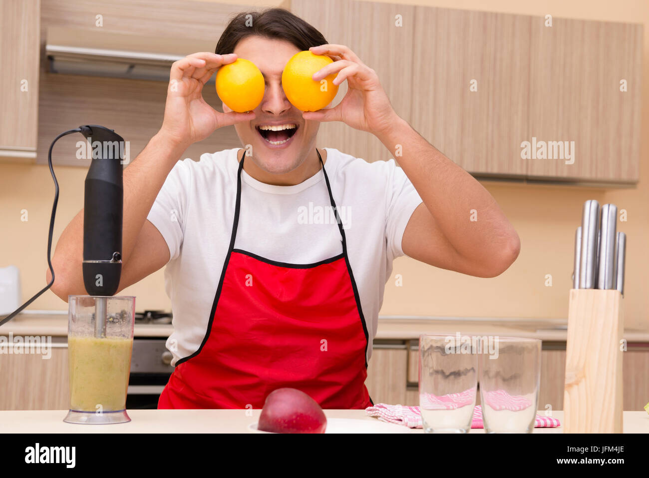 Handsome man working at the kitchen Stock Photo - Alamy