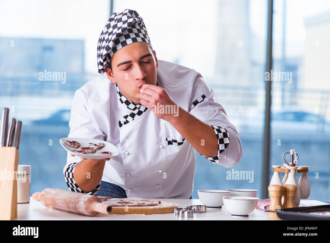 Young man cooking cookies in kitchen Stock Photo - Alamy