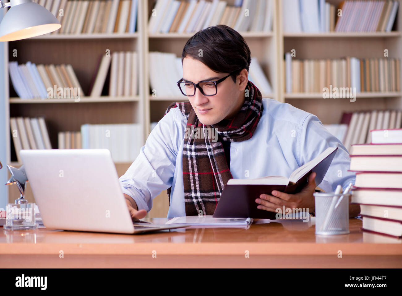 Young writer working in the library Stock Photo - Alamy