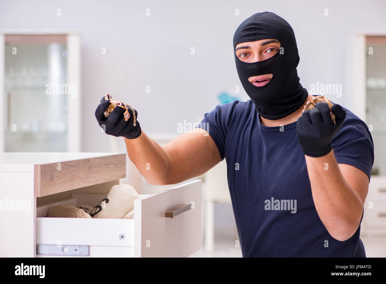 Robber wearing balaclava stealing valuable things Stock Photo - Alamy