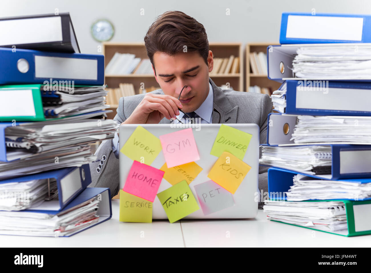 Businessman struggling with multiple priorities Stock Photo - Alamy