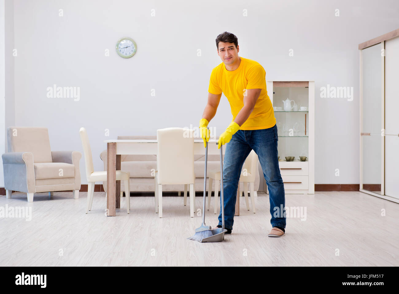Man cleaning the house helping his wife Stock Photo - Alamy