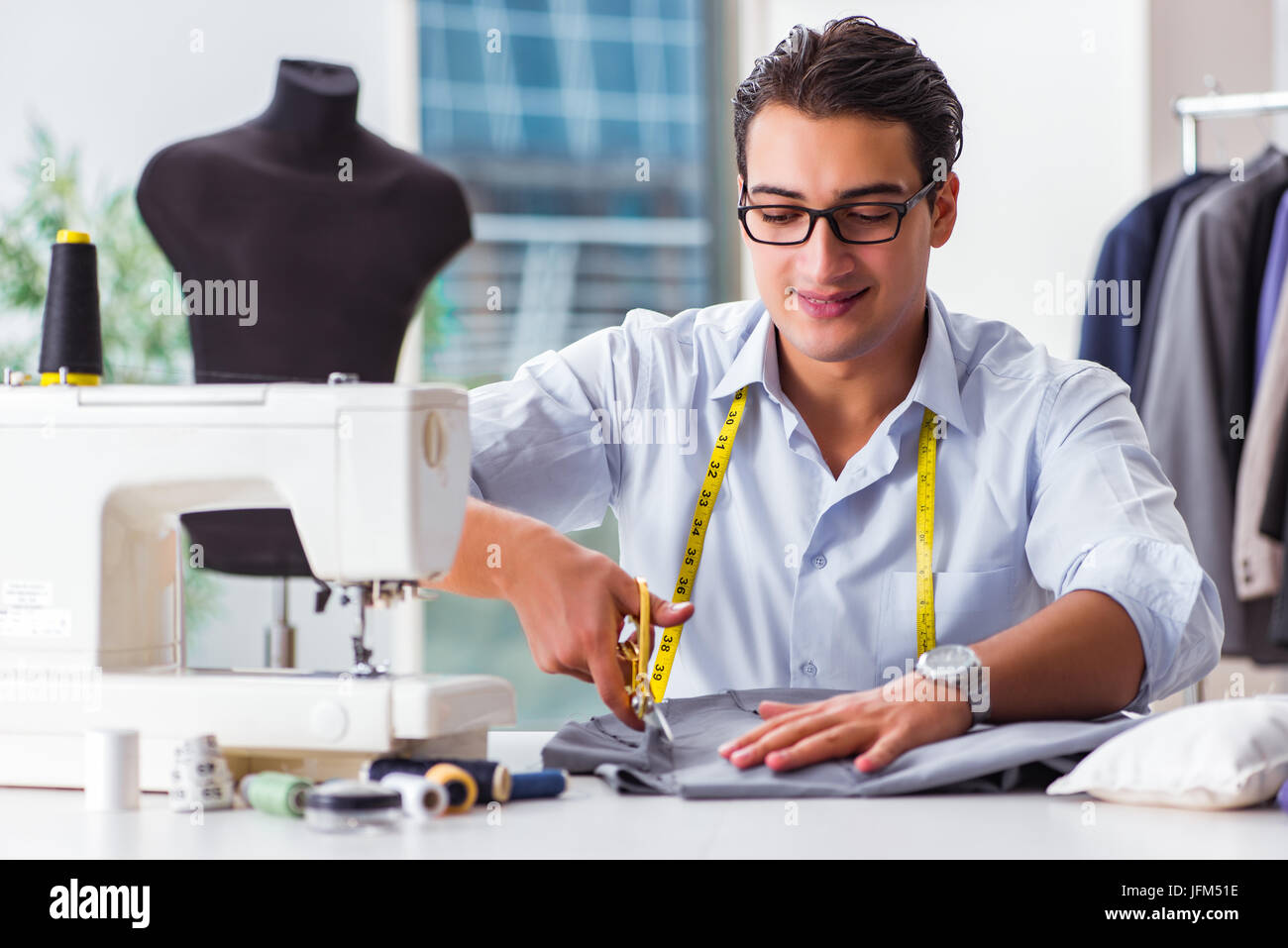 Young man tailor working on new clothing Stock Photo - Alamy