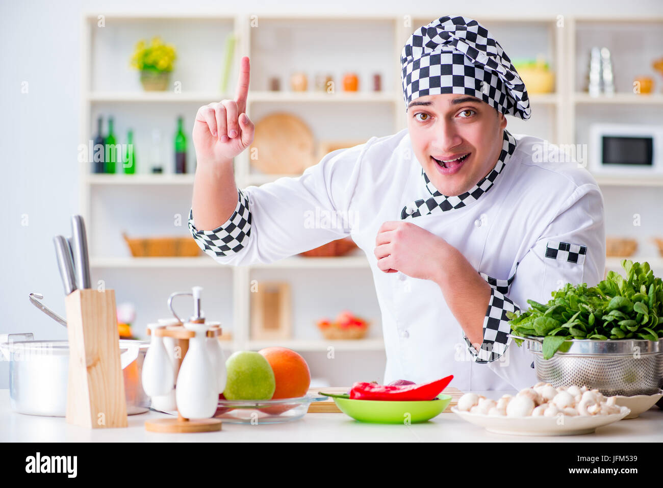 Young male cook working in the kitchen Stock Photo - Alamy
