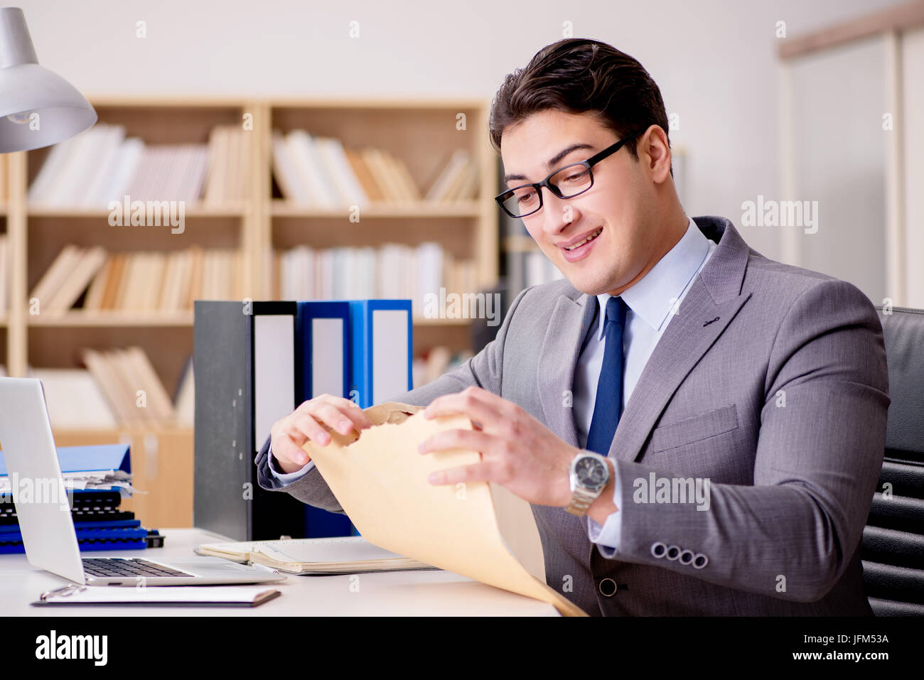 Businessman receiving letter envelope in office Stock Photo - Alamy
