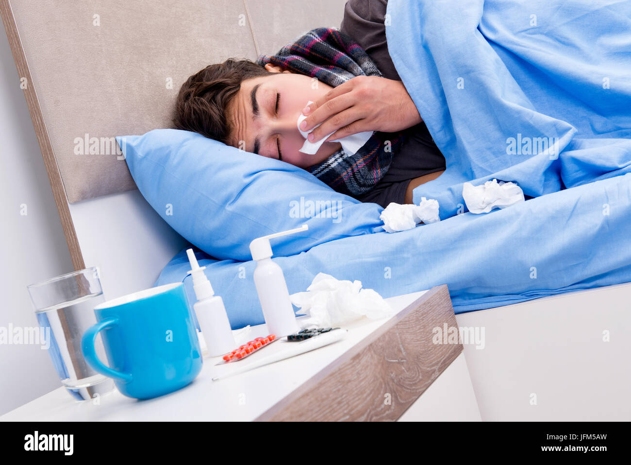 Sick ill man in the bed taking medicines and drugs Stock Photo - Alamy