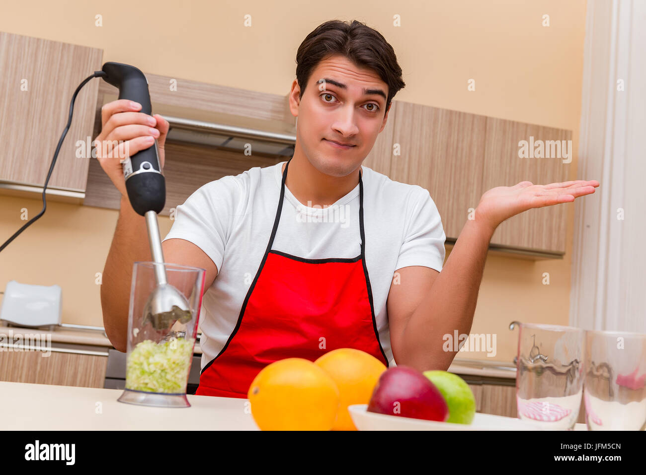 Handsome man working at the kitchen Stock Photo - Alamy