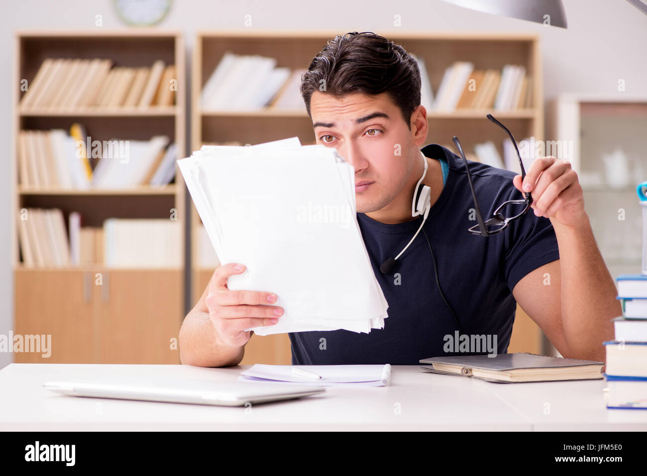Angry man with too much paperwork to do Stock Photo - Alamy