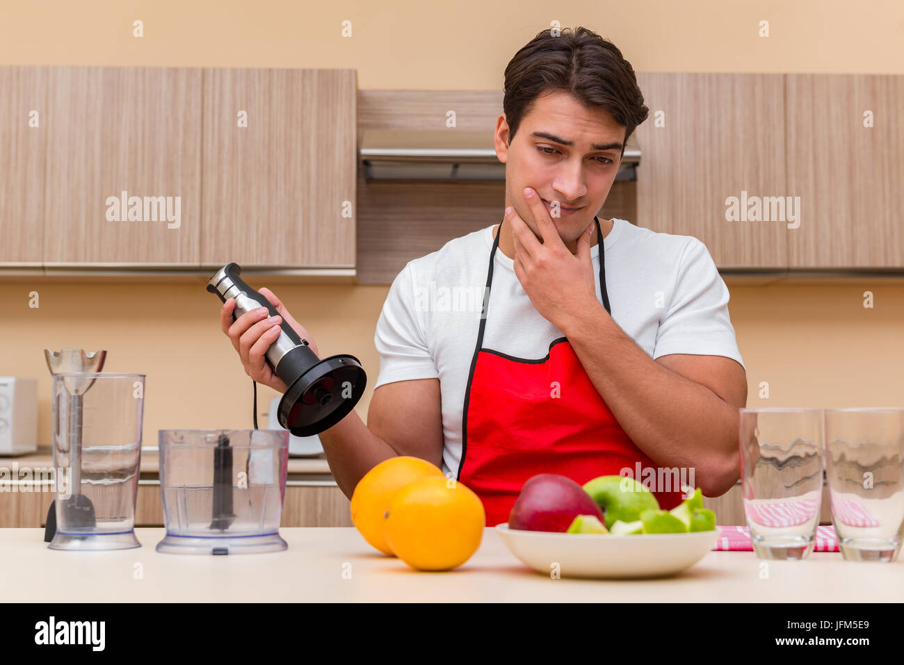 Handsome man working at the kitchen Stock Photo - Alamy