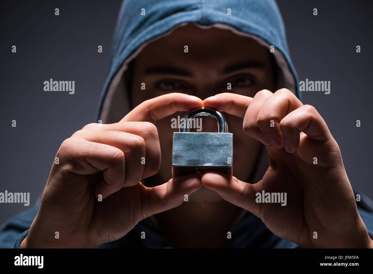 Computer hacker working in dark room Stock Photo - Alamy