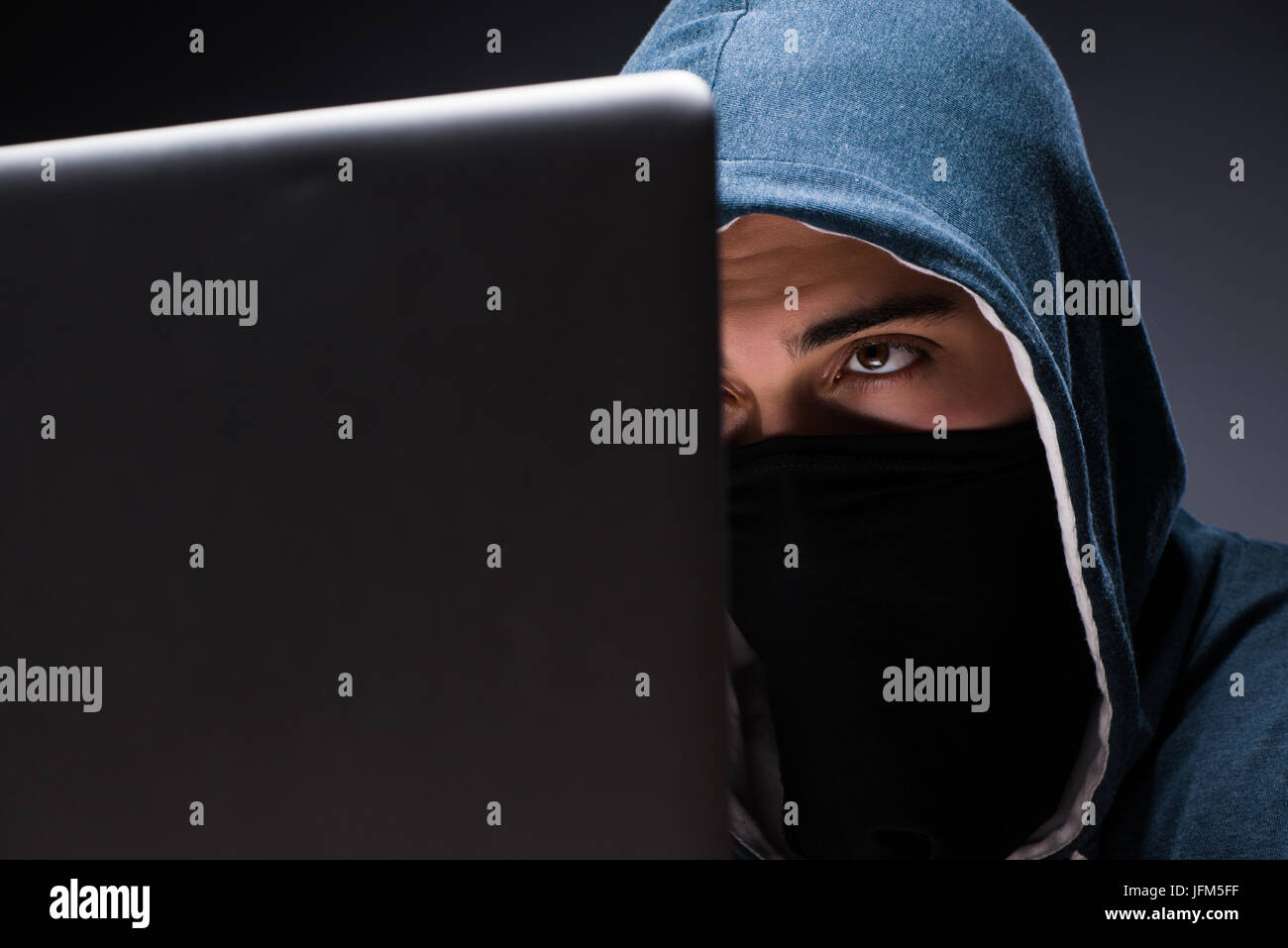 Computer hacker working in dark room Stock Photo - Alamy