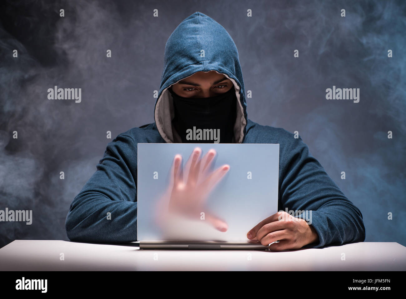 Computer hacker working in dark room Stock Photo - Alamy