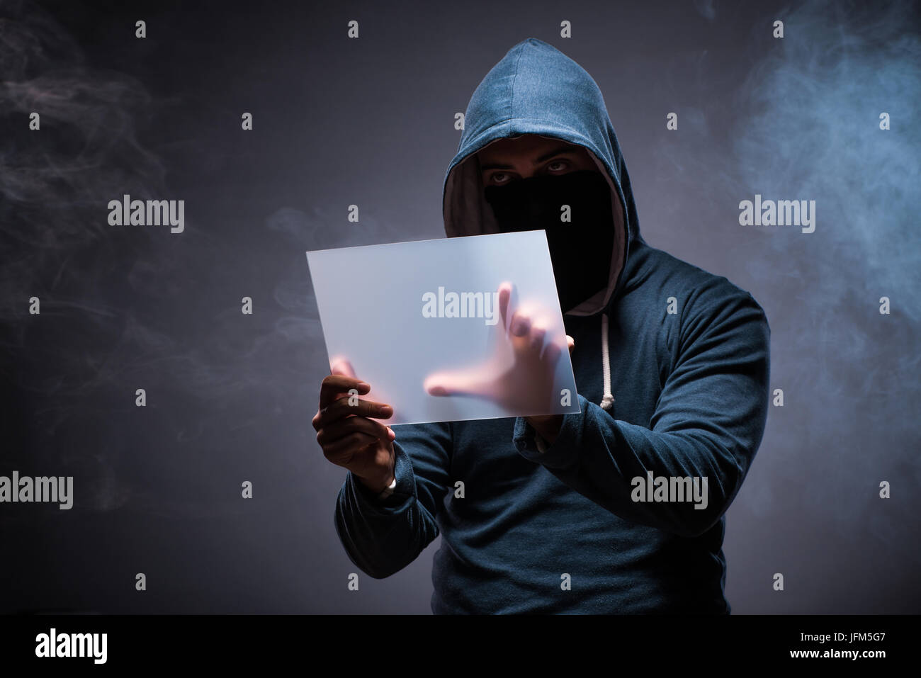 Hacker working on tablet in dark Stock Photo - Alamy