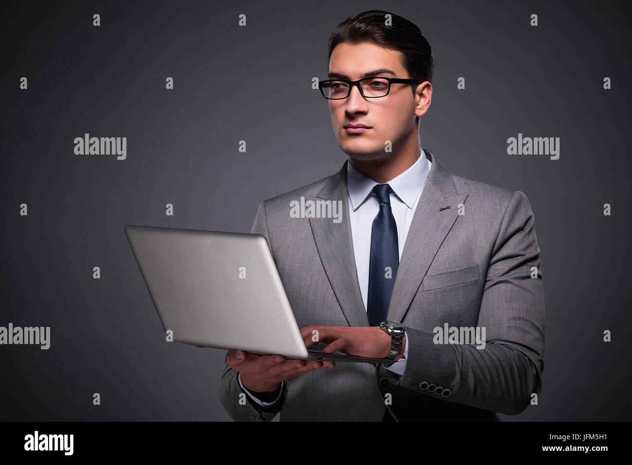 Handsome businessman working on laptop computer Stock Photo - Alamy