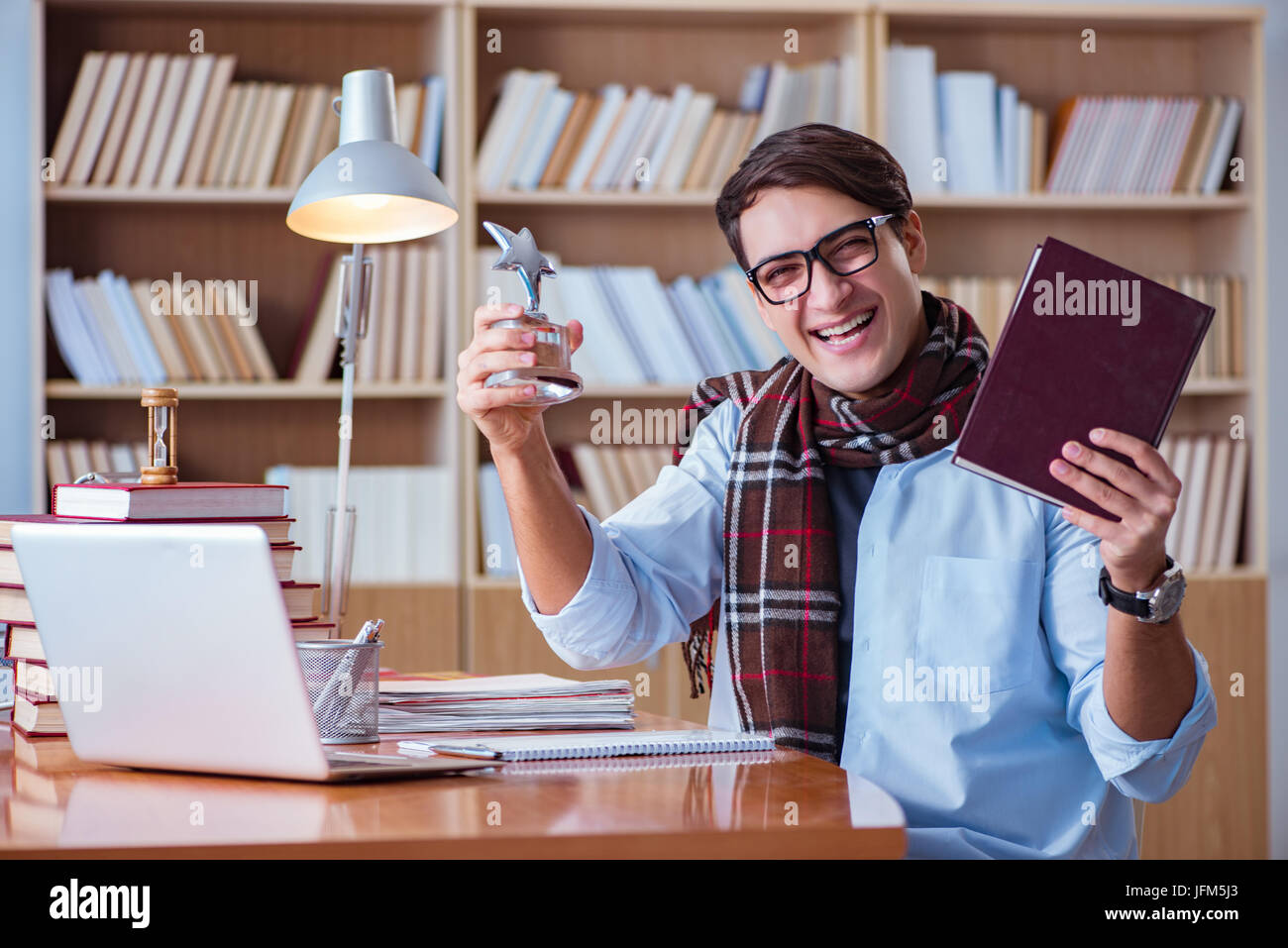 Young book writer writing in library Stock Photo - Alamy