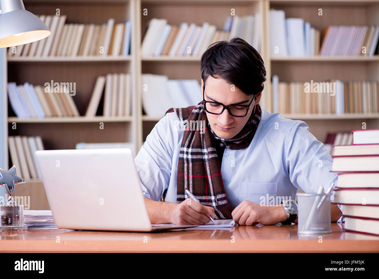 Young writer working in the library Stock Photo - Alamy