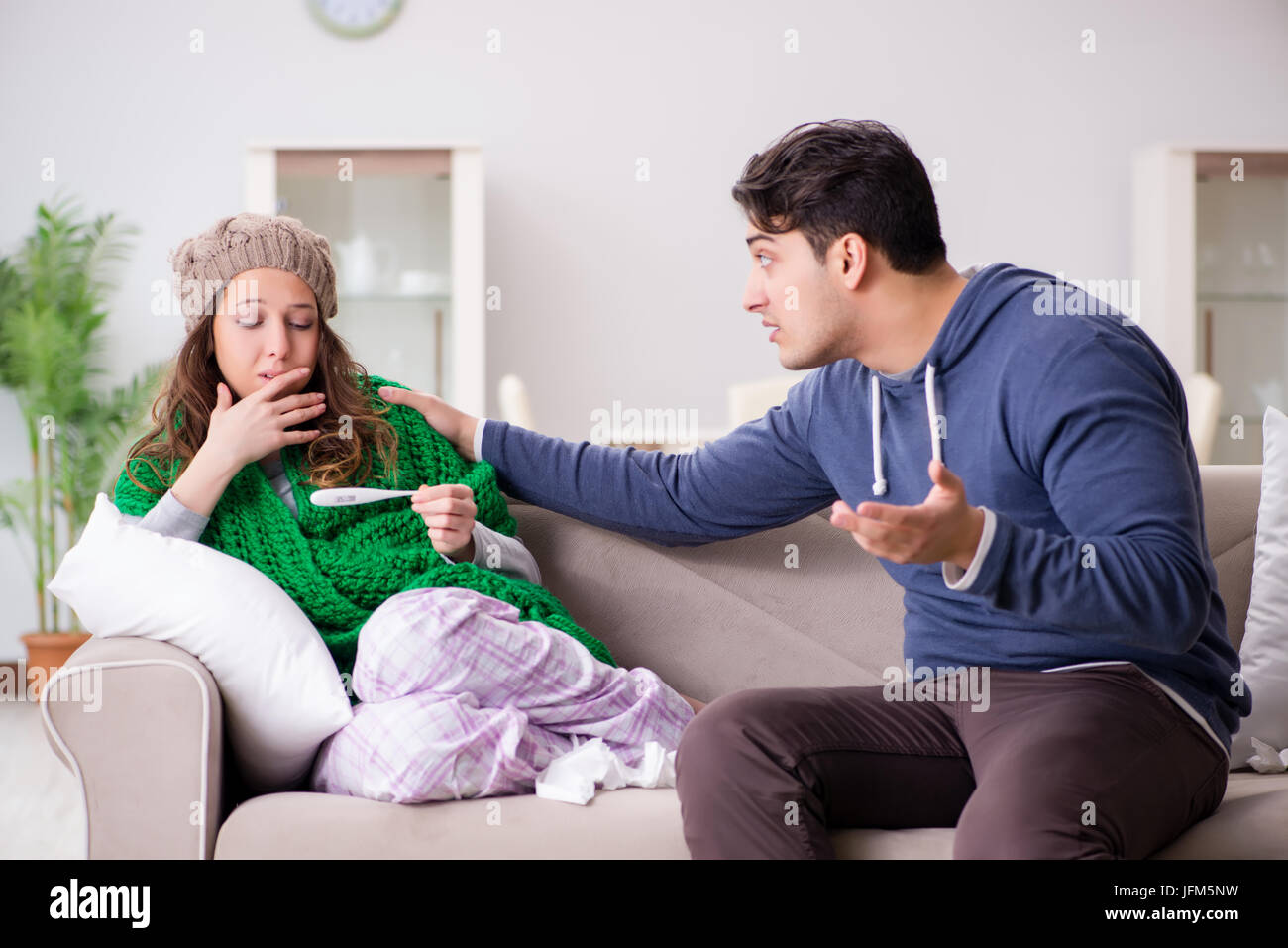 Husband caring for sick wife Stock Photo - Alamy