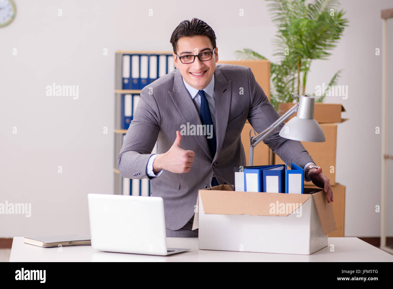 Young handsome businessman moving offices Stock Photo - Alamy