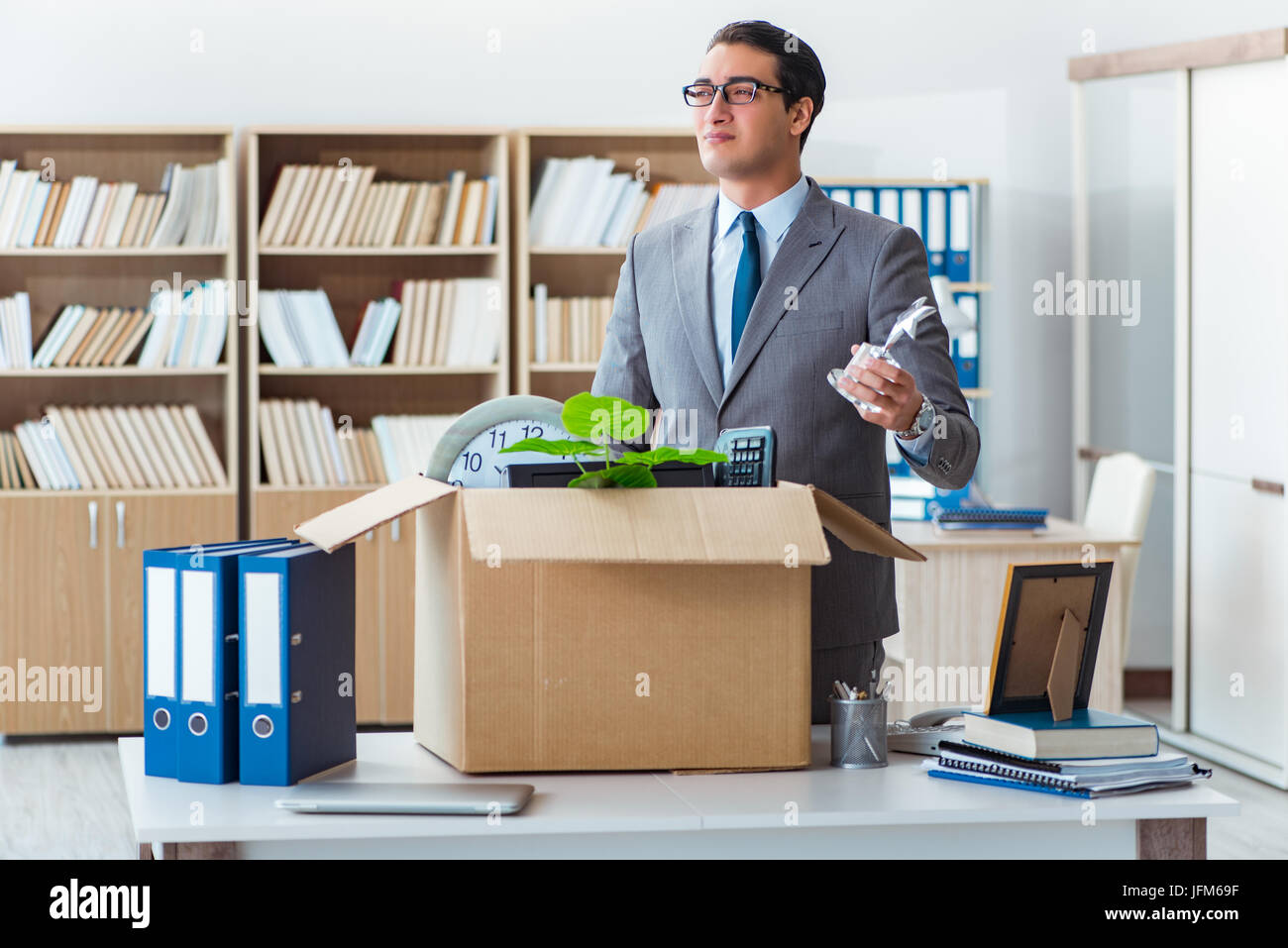 Man moving office with box and his belongings Stock Photo - Alamy