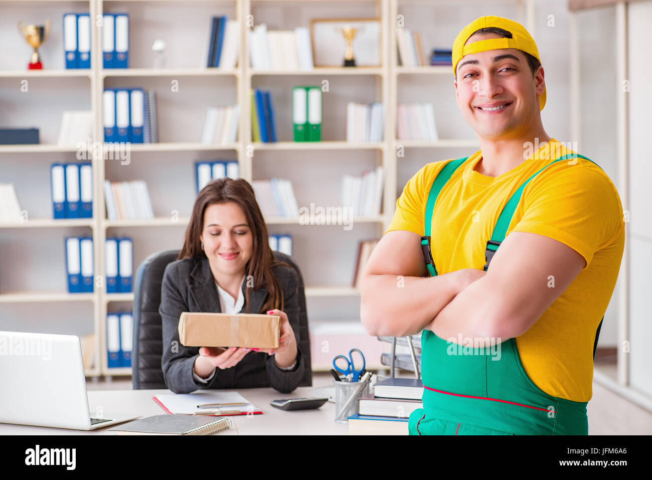 Postman delivering parcel to the office Stock Photo - Alamy