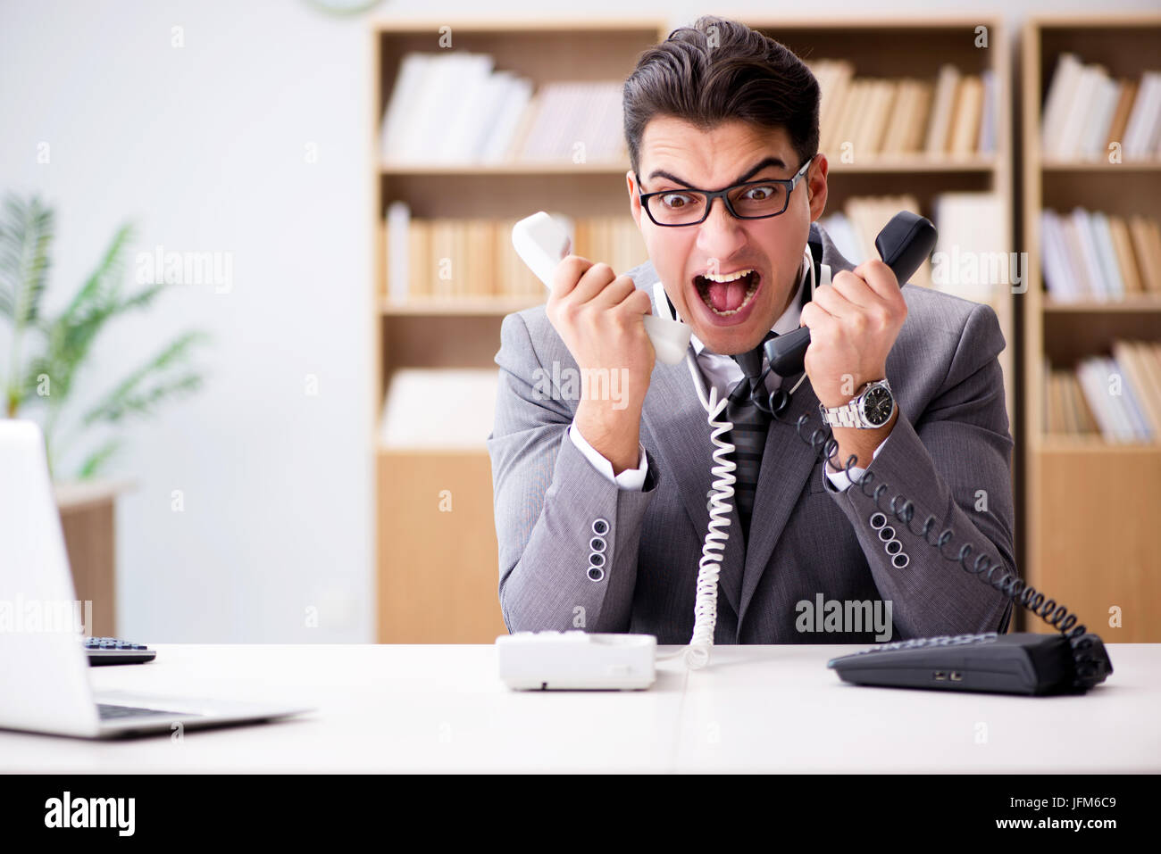 Angry helpdesk operator yelling in office Stock Photo - Alamy