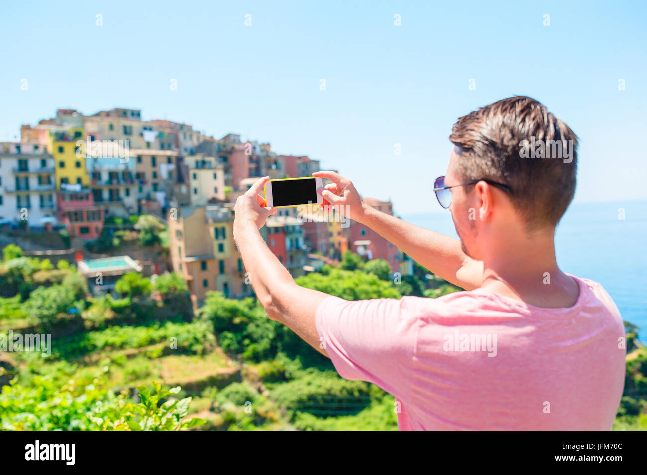 Young man taking selfie background beautiful old italian village ...