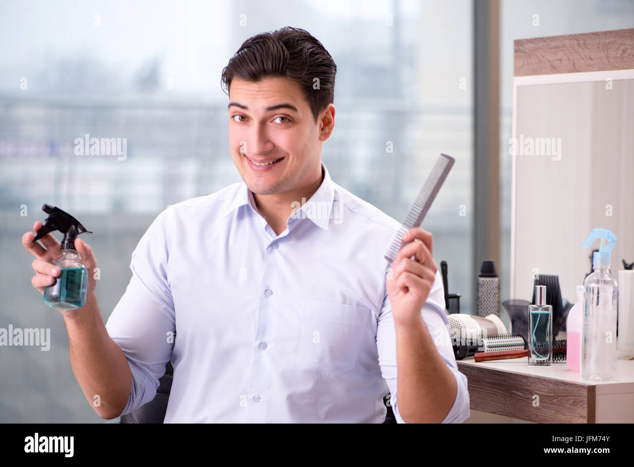 Handsome man in beauty salon Stock Photo - Alamy